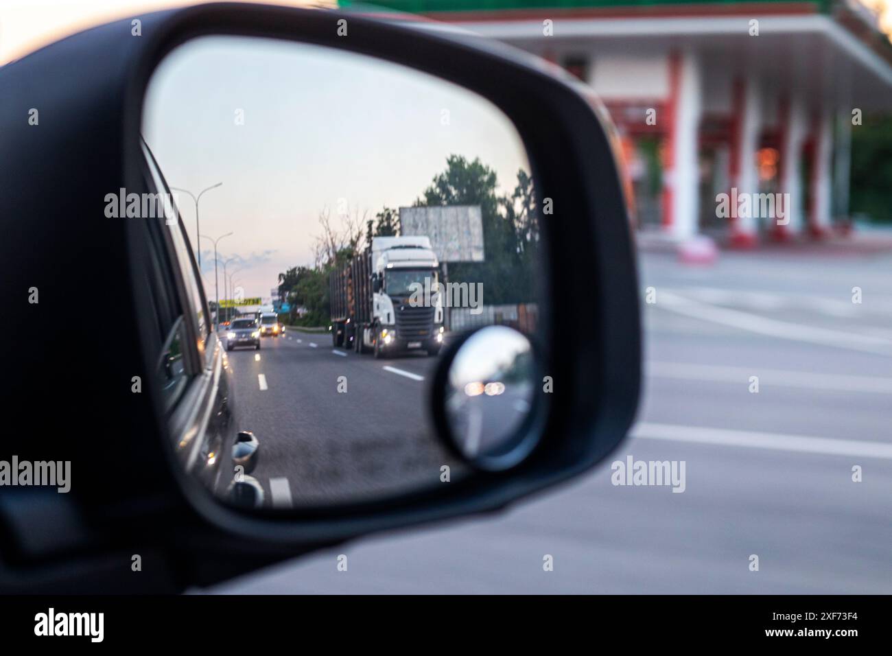 truck in the car's right side mirror while the car is driving in the ...