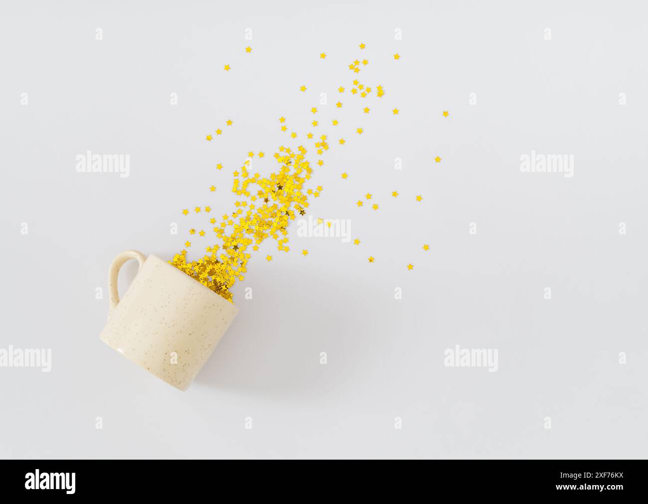 Creative layout made with coffee cup and golden glitter stars confetti ...