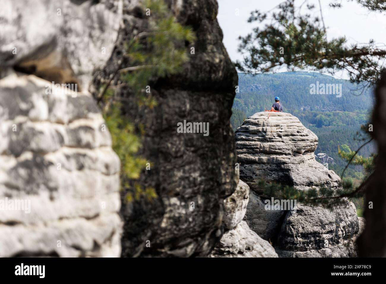 Tired rock climber resting break on peak summit rocky sansdtone ...