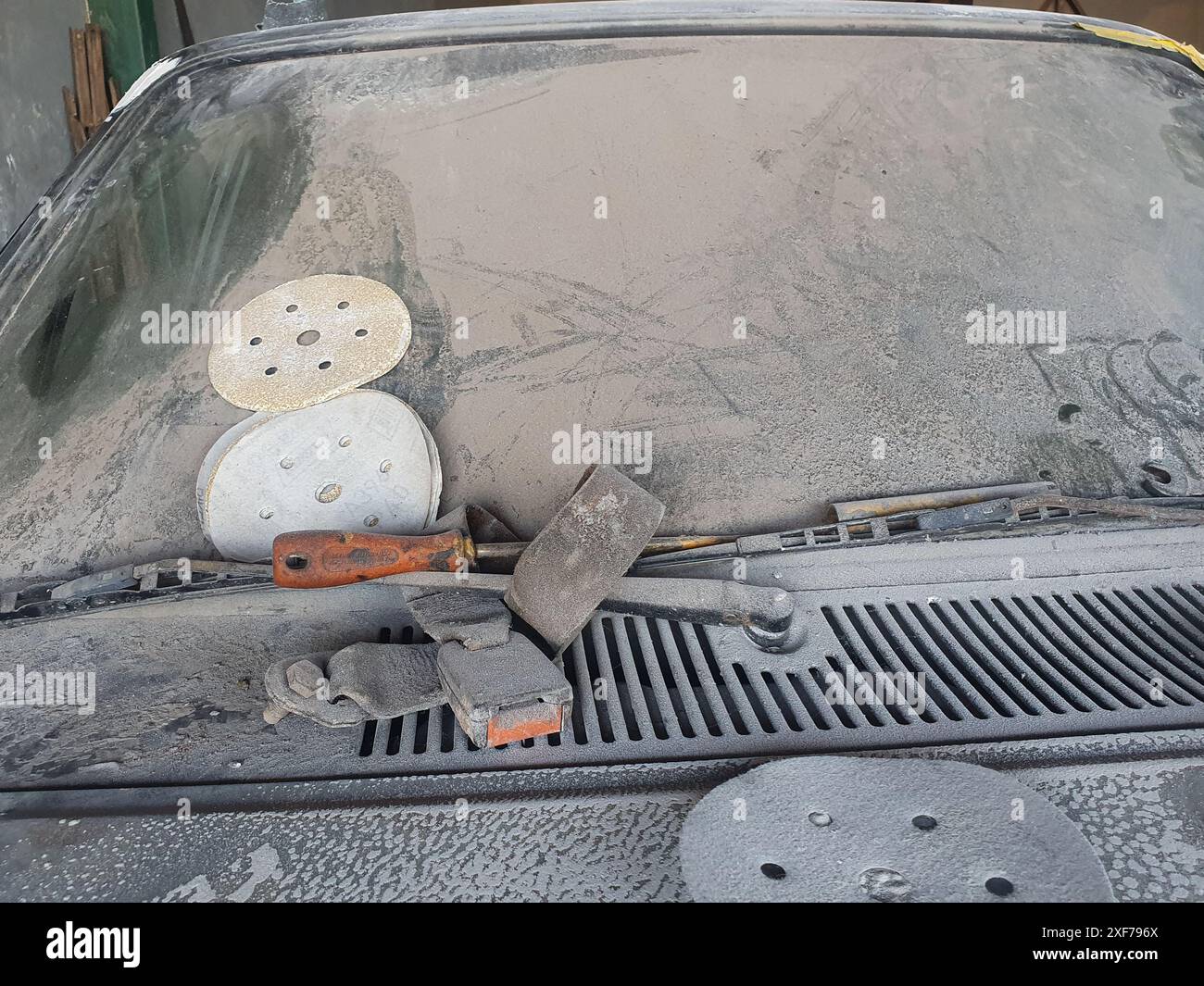 Windshield of an old car, all dirty, dusty, with white powder ...