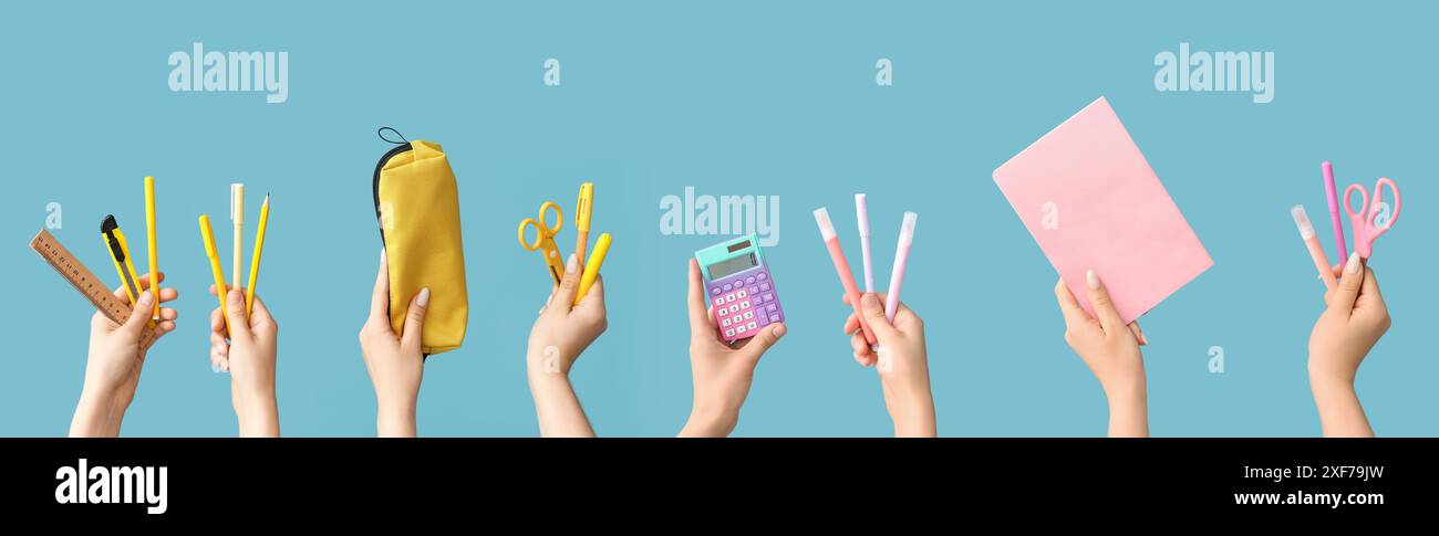 Many hands holding school supplies on light blue background Stock Photo ...