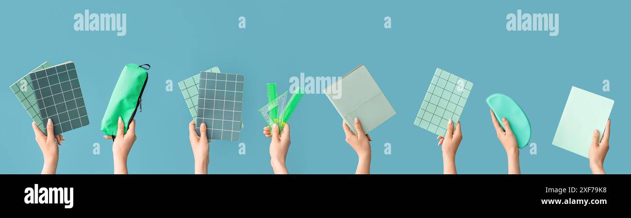 Many hands holding school supplies on light blue background Stock Photo ...
