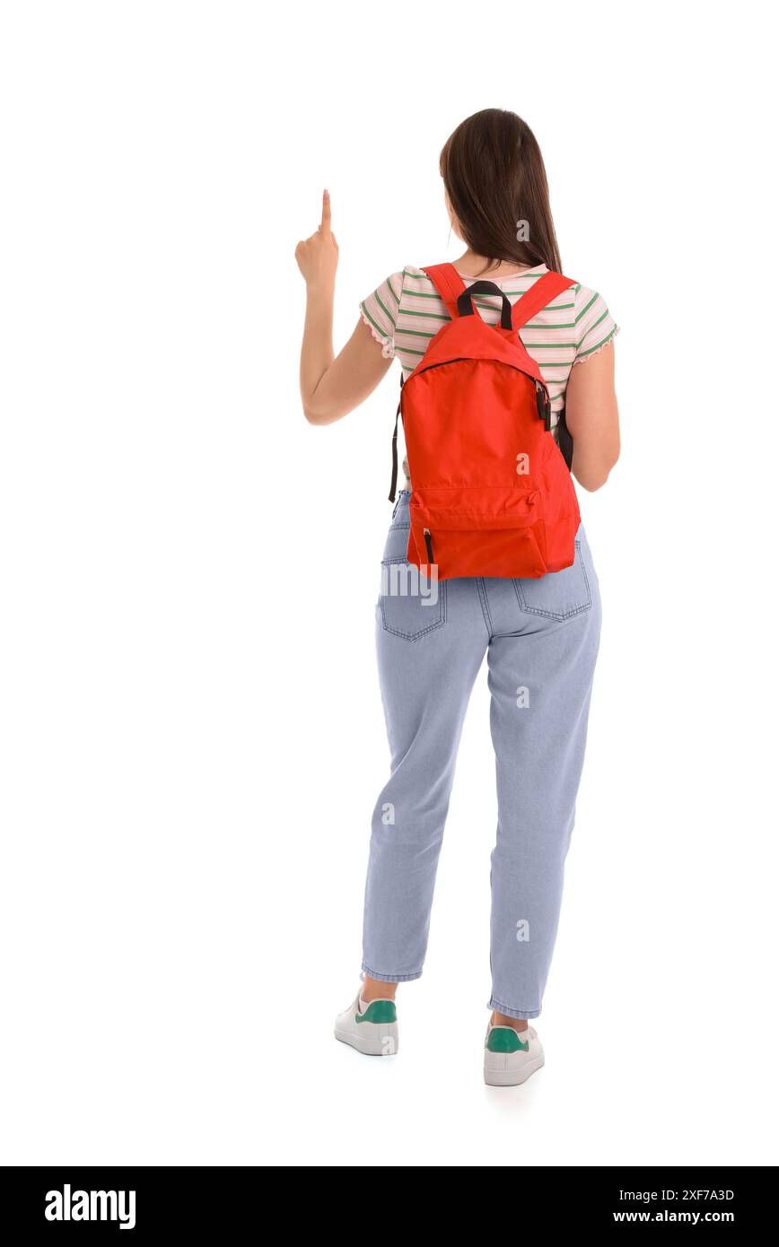 Female student with backpack pointing at something on white background ...