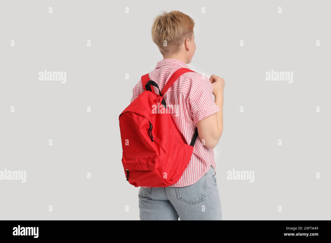 Female student with backpack on white background, back view Stock Photo ...