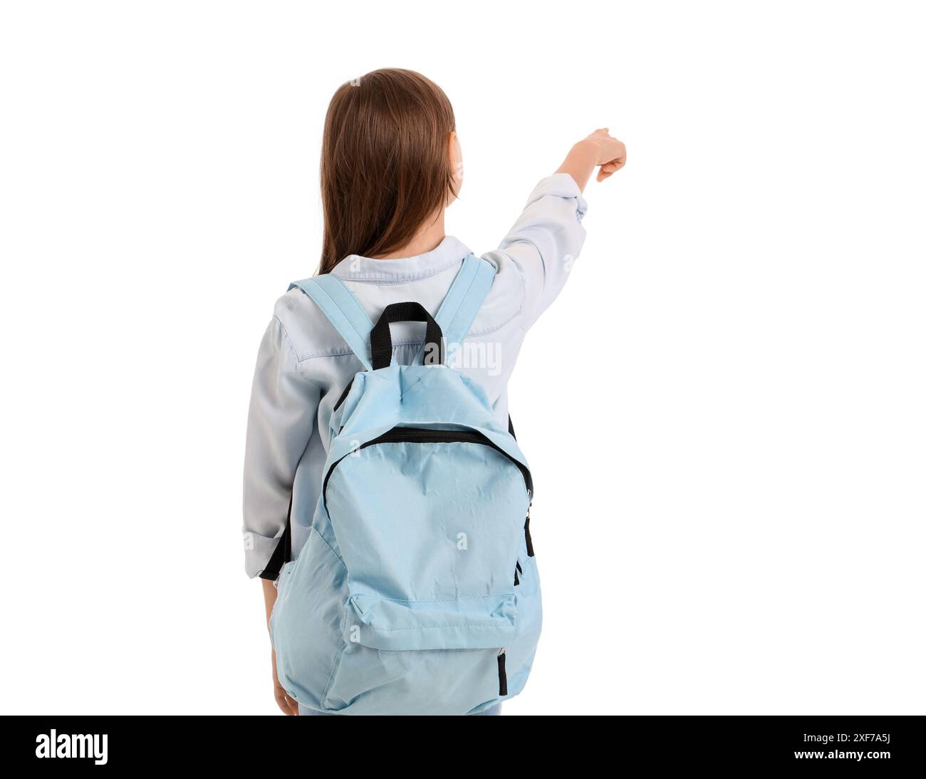 Little girl with schoolbag pointing at something on white background ...