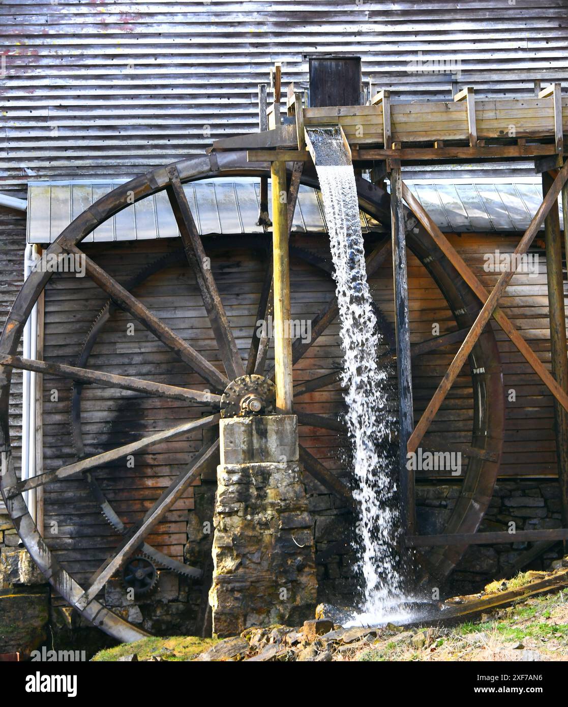 Historic Bush Grist Mill is operational. Water flows through shute, and ...