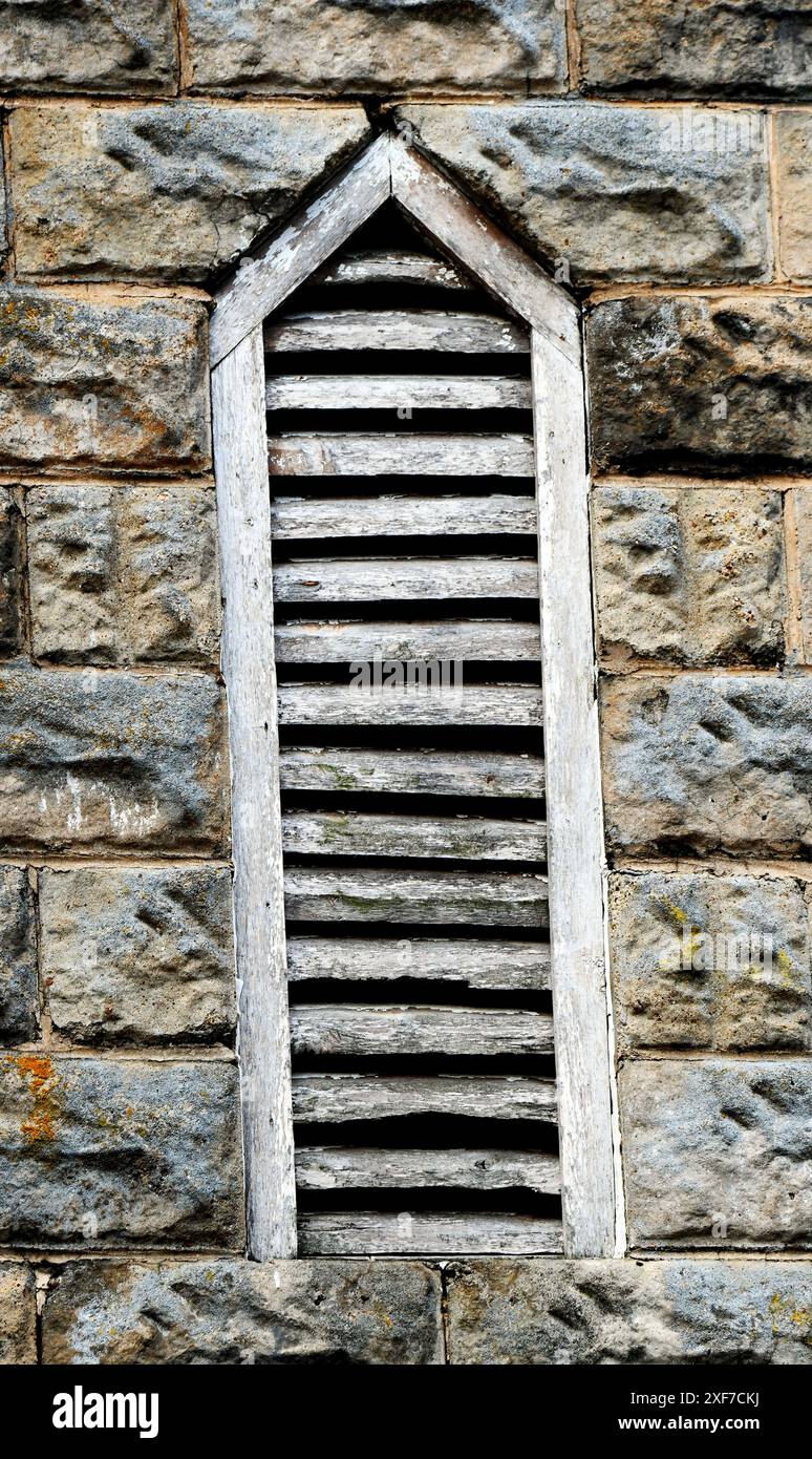 Stone church has weathered, wooden shutter Stock Photo - Alamy