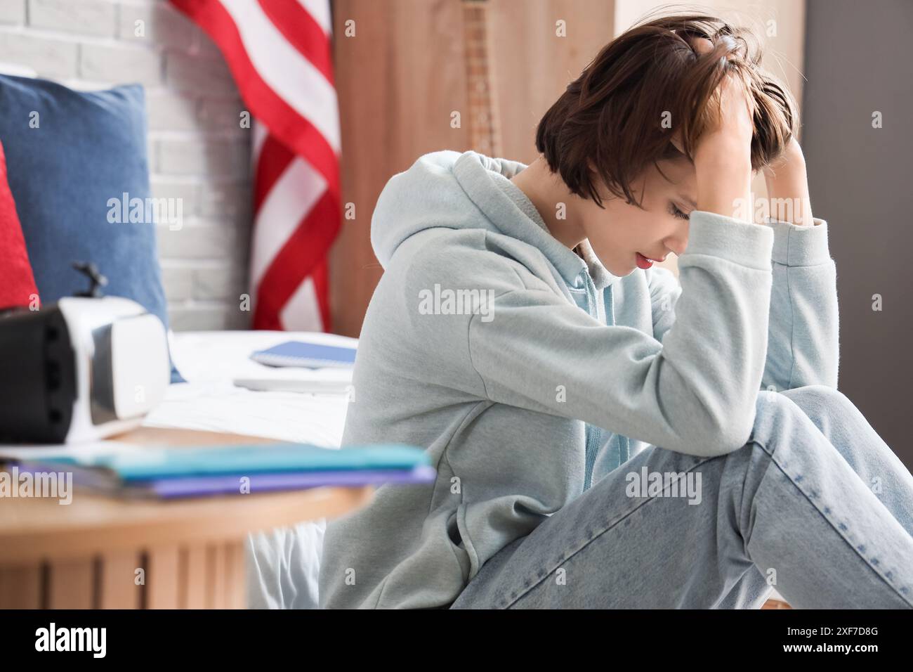 Stressed female student sitting in bedroom Stock Photo - Alamy