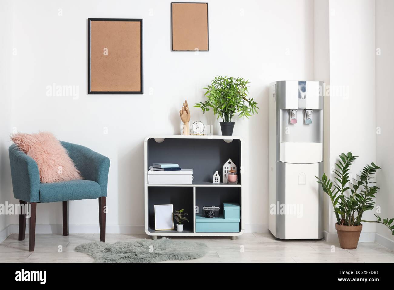 Interior of room with modern water cooler near white wall Stock Photo ...