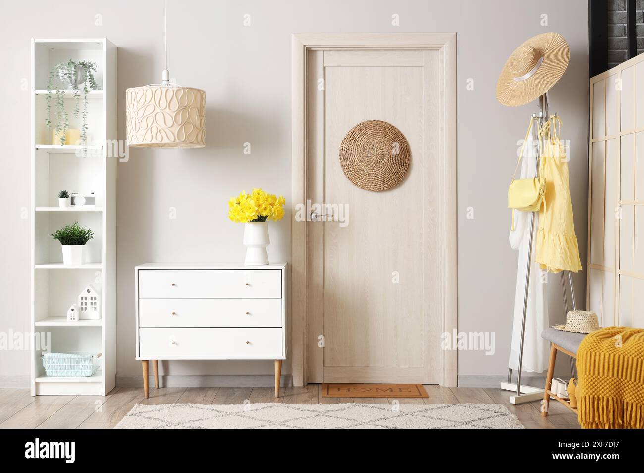 Stylish interior of hall with shelving unit, clothes rack, chest of ...