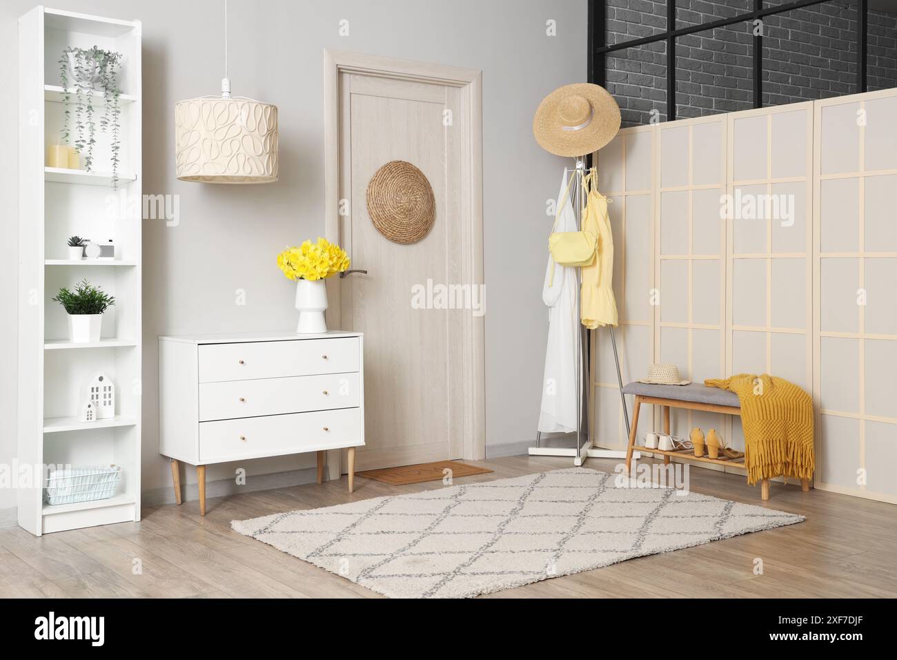 Stylish interior of hall with shelving unit, clothes rack, chest of ...