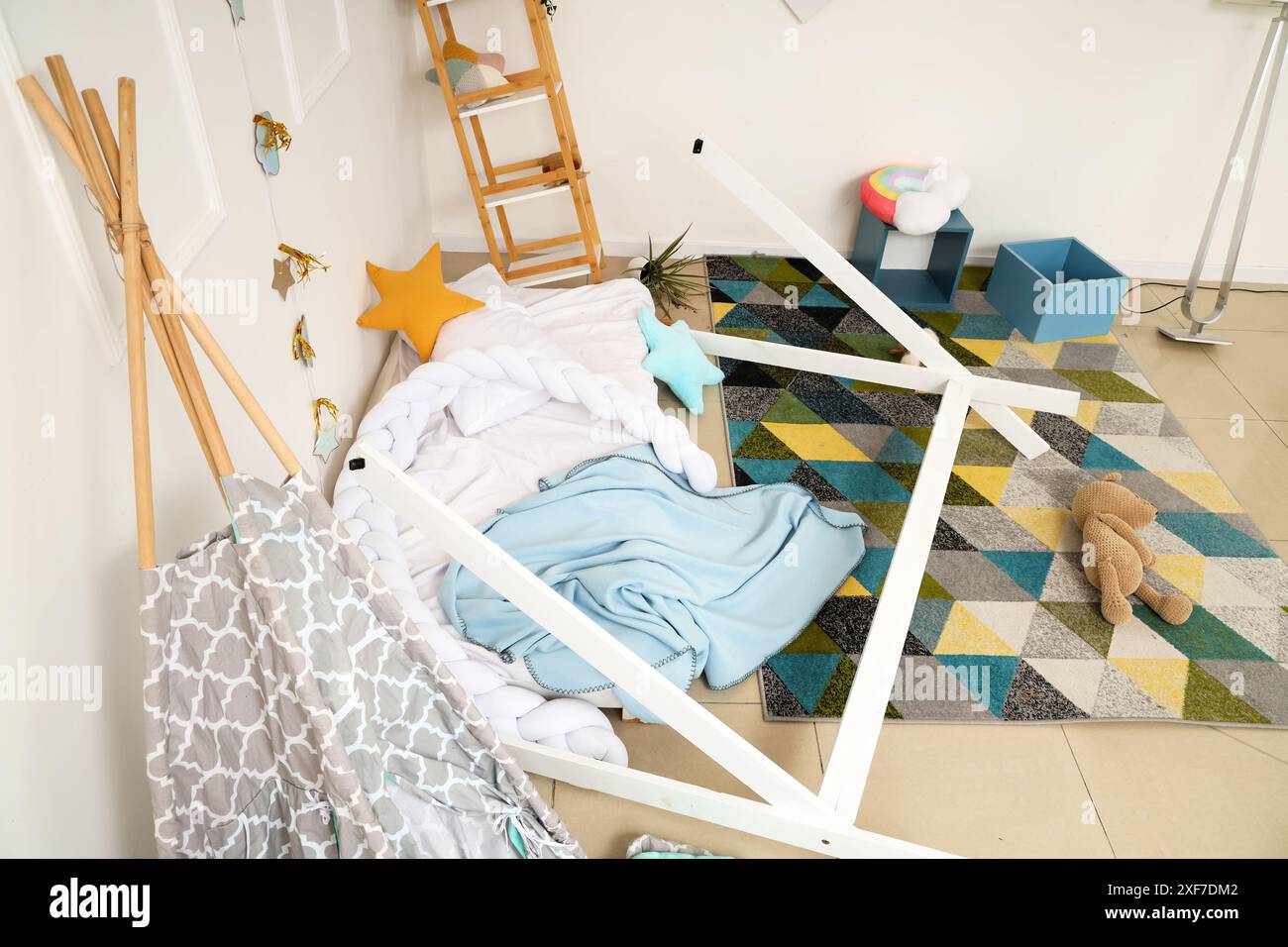 Broken bed on floor in messy children's room Stock Photo - Alamy