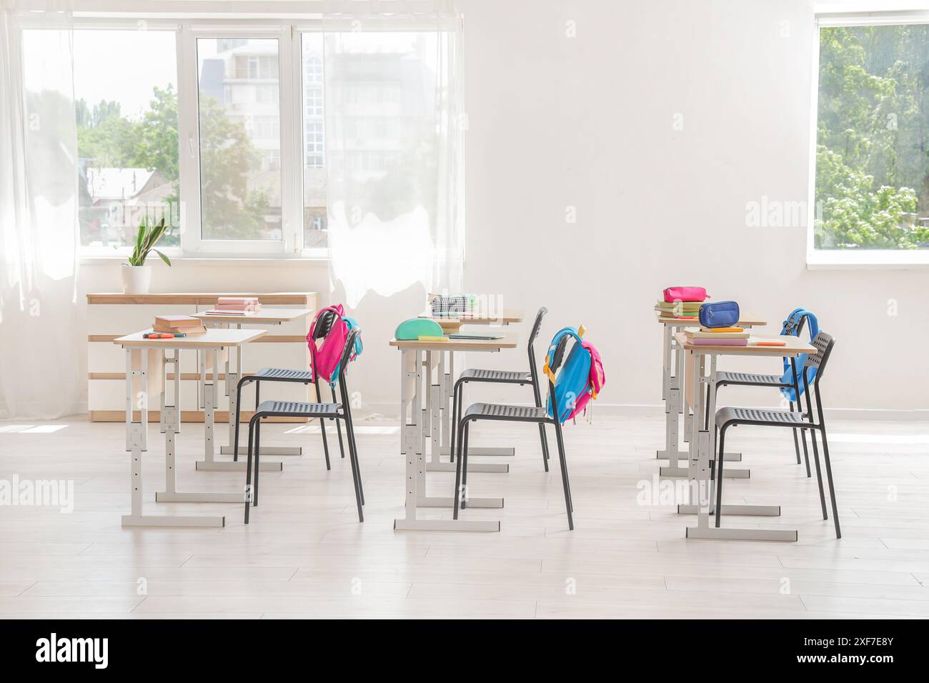 Interior of classroom with desks and backpacks Stock Photo - Alamy