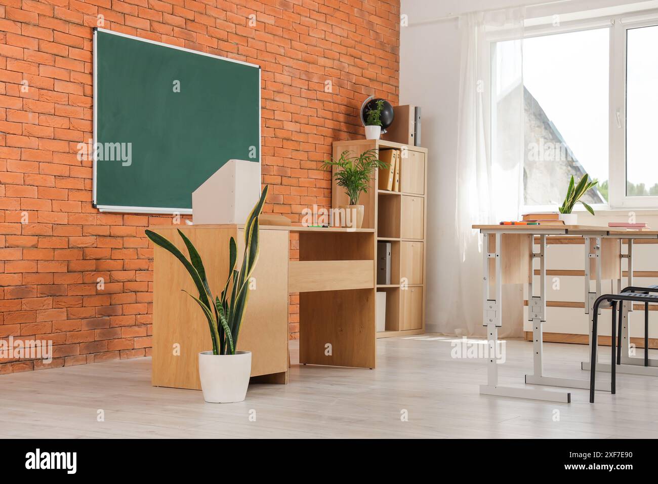 Interior of classroom with chalkboard, teacher's table and plants Stock ...