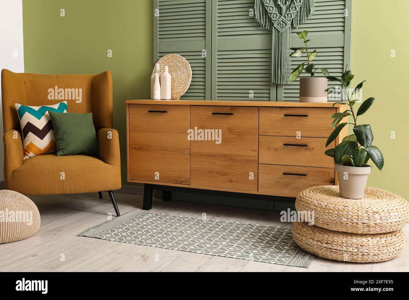 Cozy armchair and chest of drawers in interior of living room Stock ...