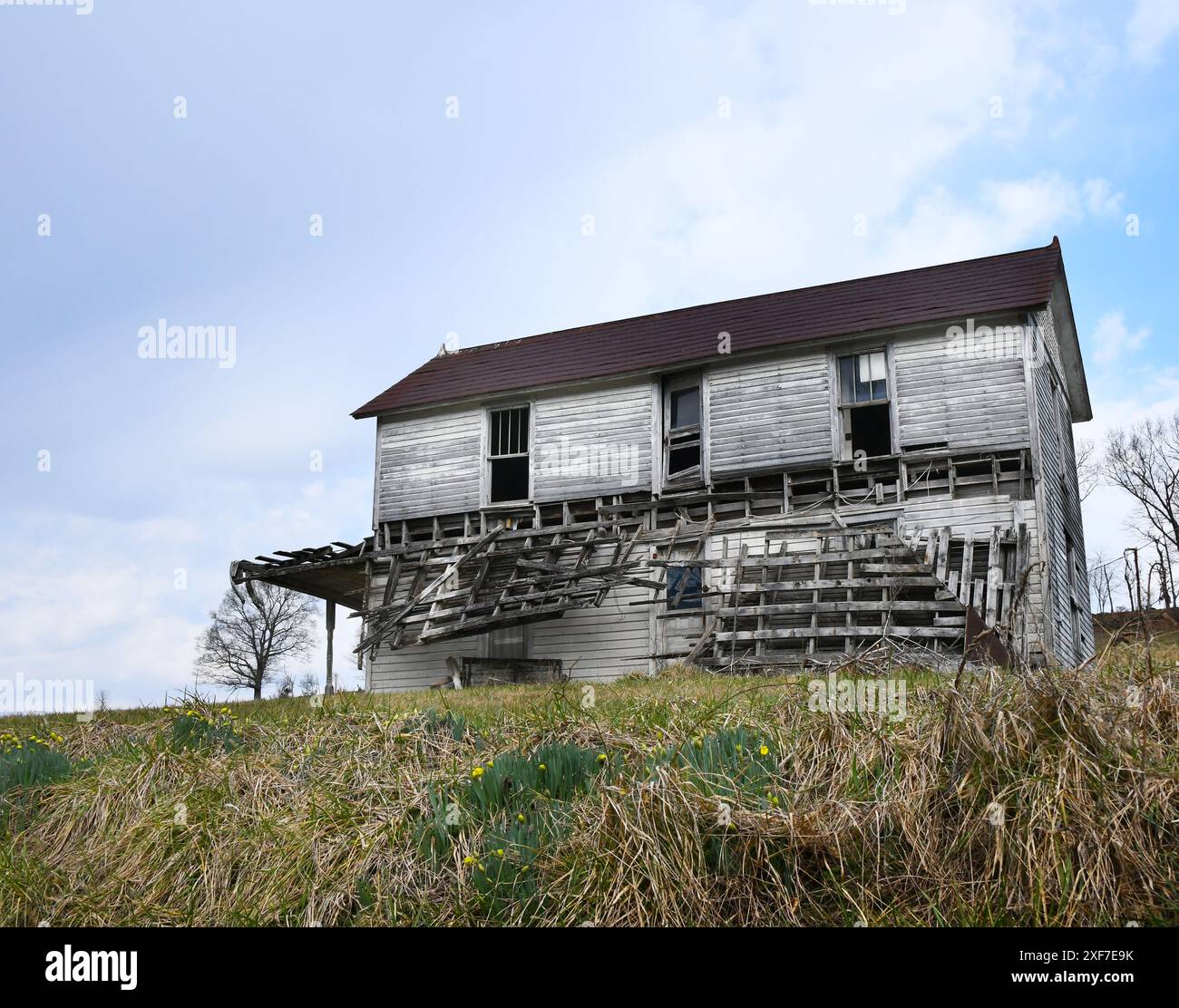 Porch roof has collapsed on this old home. Exterior, of house, was ...