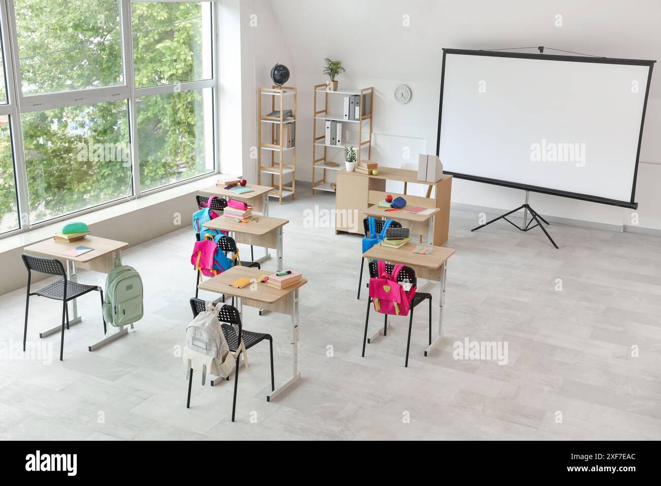 Interior of light classroom with projector screen and desks Stock Photo ...