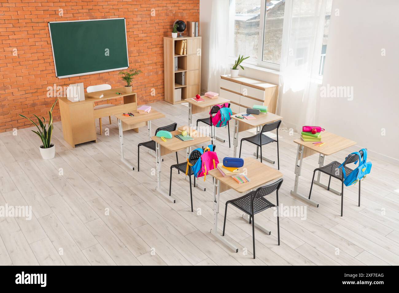 Interior of classroom with chalkboard, desks and backpacks Stock Photo ...