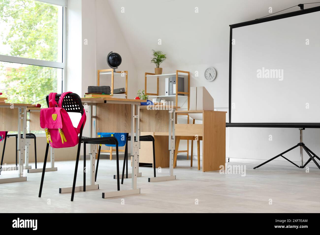 Interior of light classroom with projector screen and desks Stock Photo ...