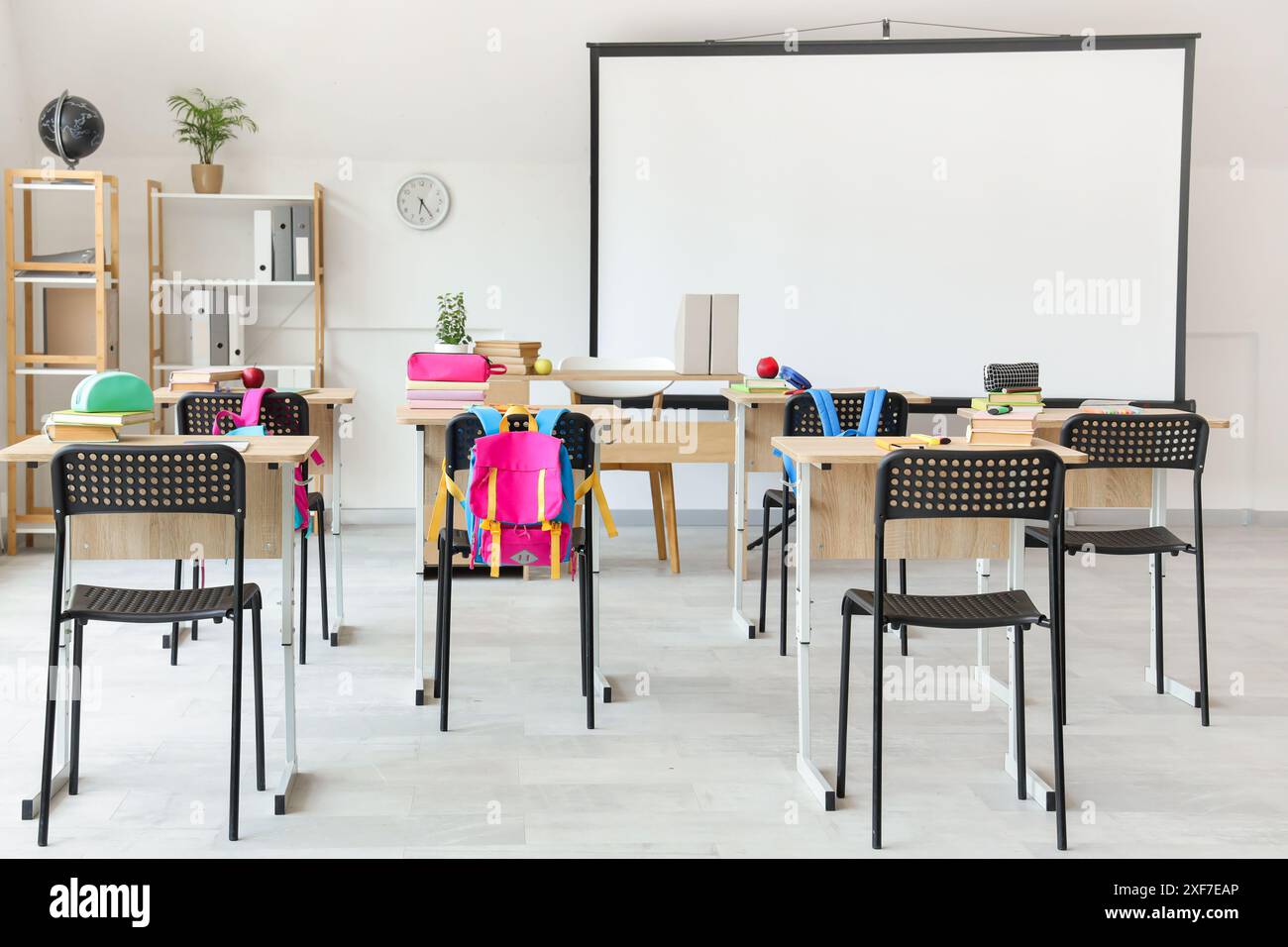 Interior of light classroom with projector screen and desks Stock Photo ...