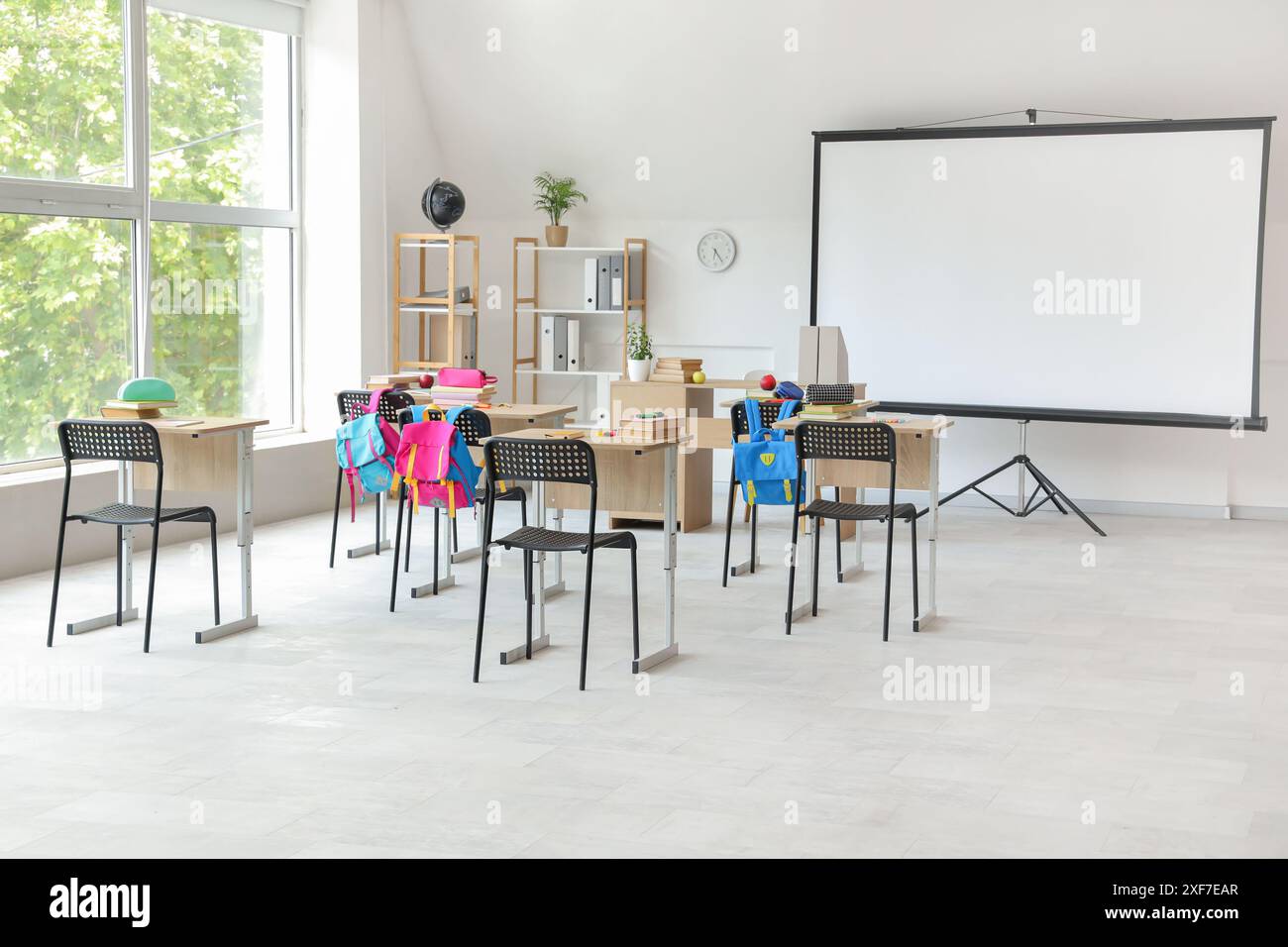 Interior of light classroom with projector screen and desks Stock Photo ...
