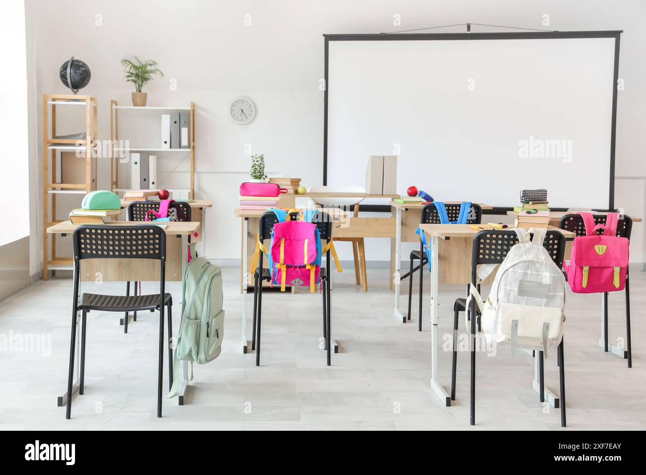 Interior of light classroom with projector screen and desks Stock Photo ...