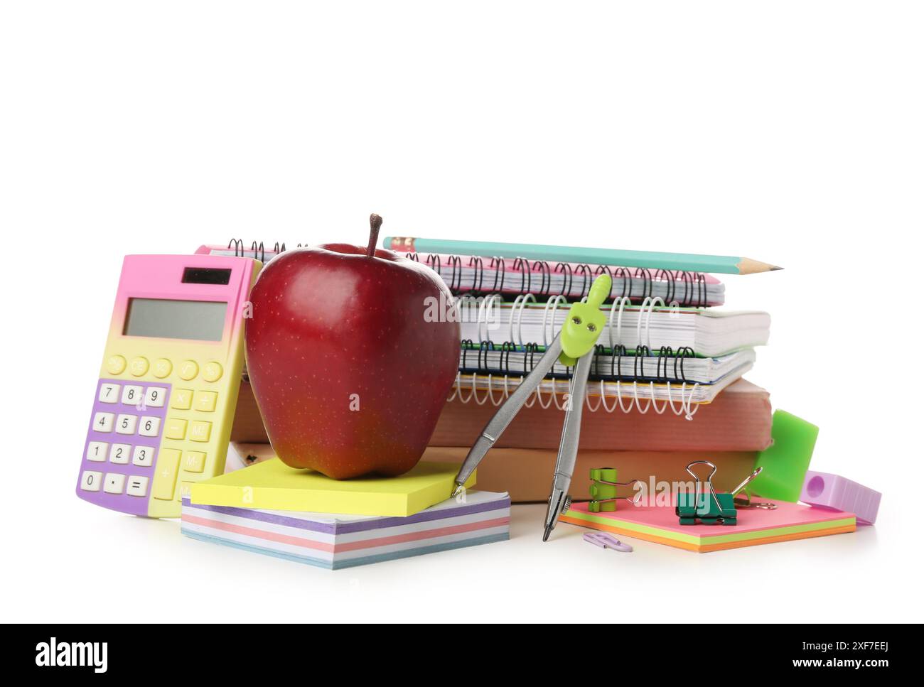 Red apple and school supplies with calculator and dividers on white ...
