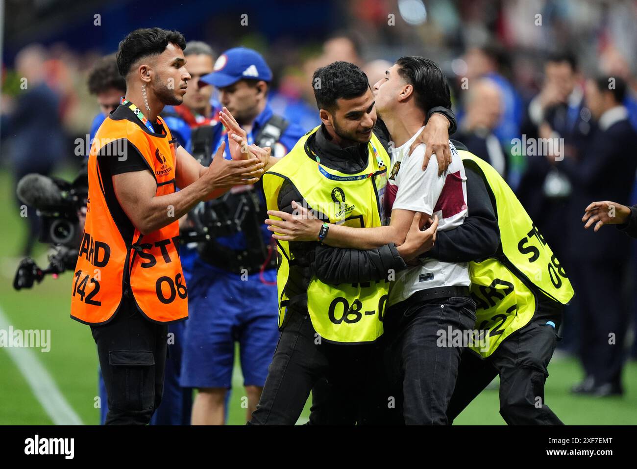 A pitch invader is removed from the pitch by stadium stewards after the ...