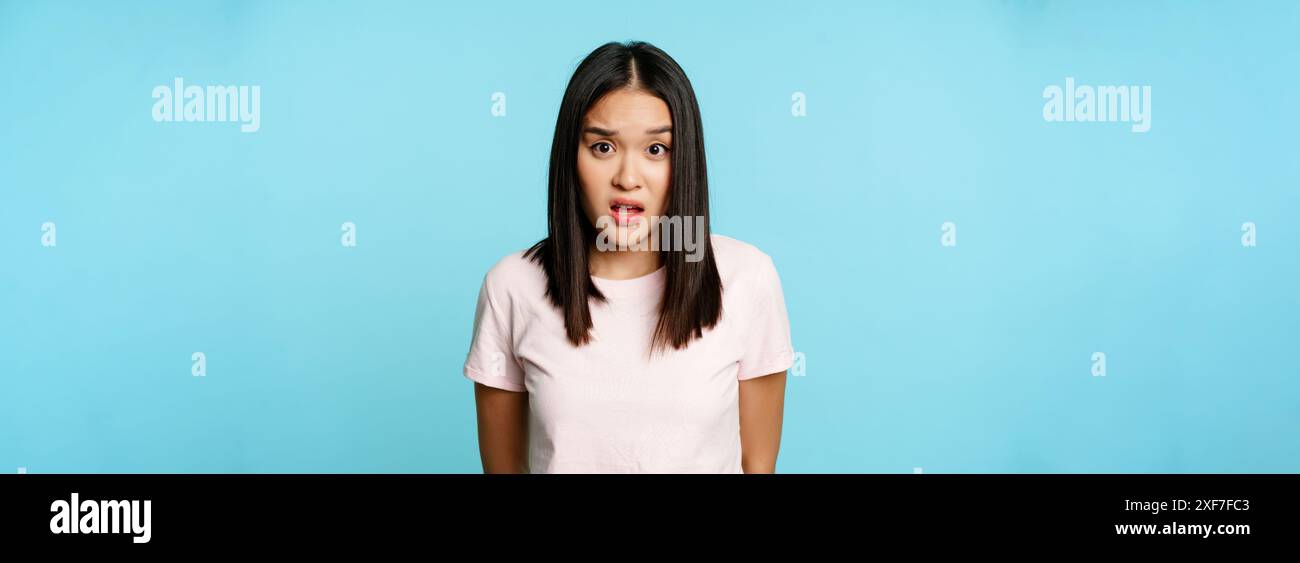 Image of asian korean girl look surprised, raising eyebrows confused ...