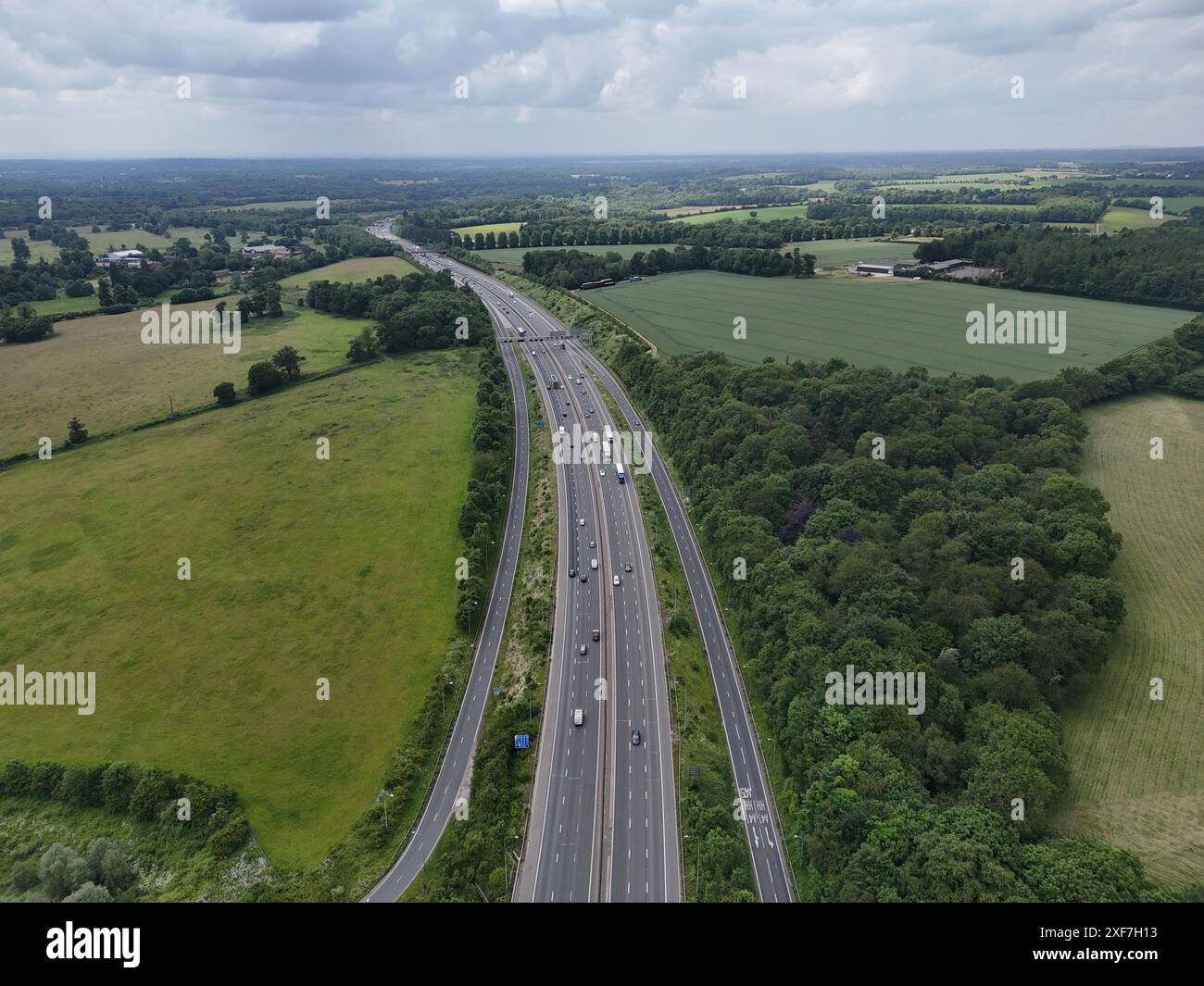 An aerial view of a busy highway interchange surrounded by green fields ...