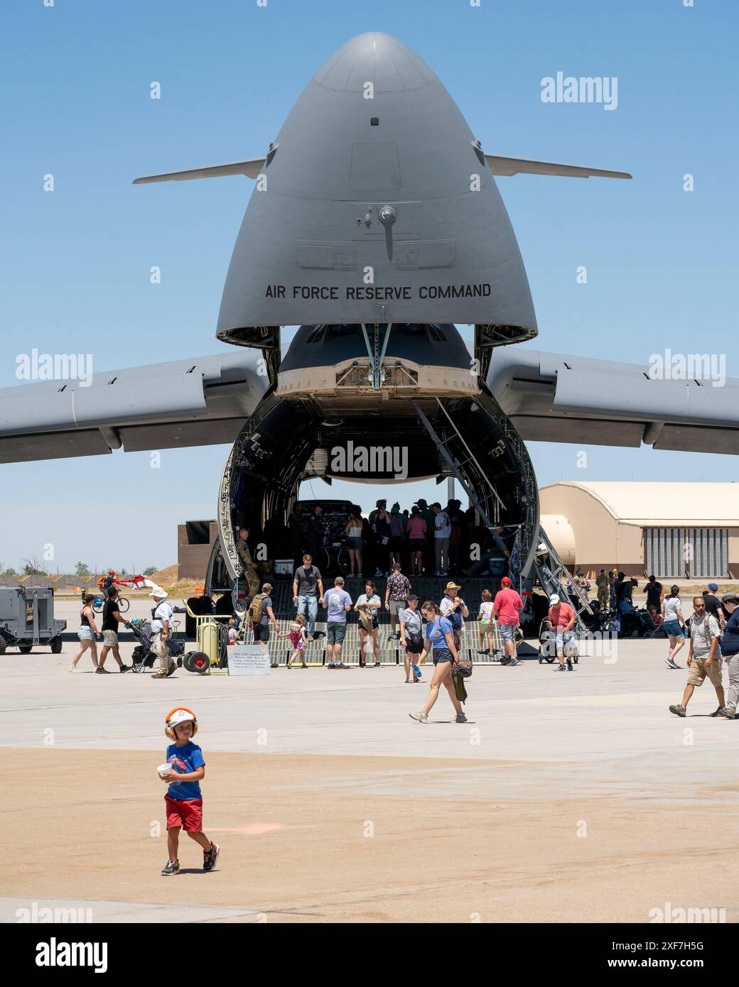 Spectators observe a C-5 Super Galaxy as part of the Warriors over the ...