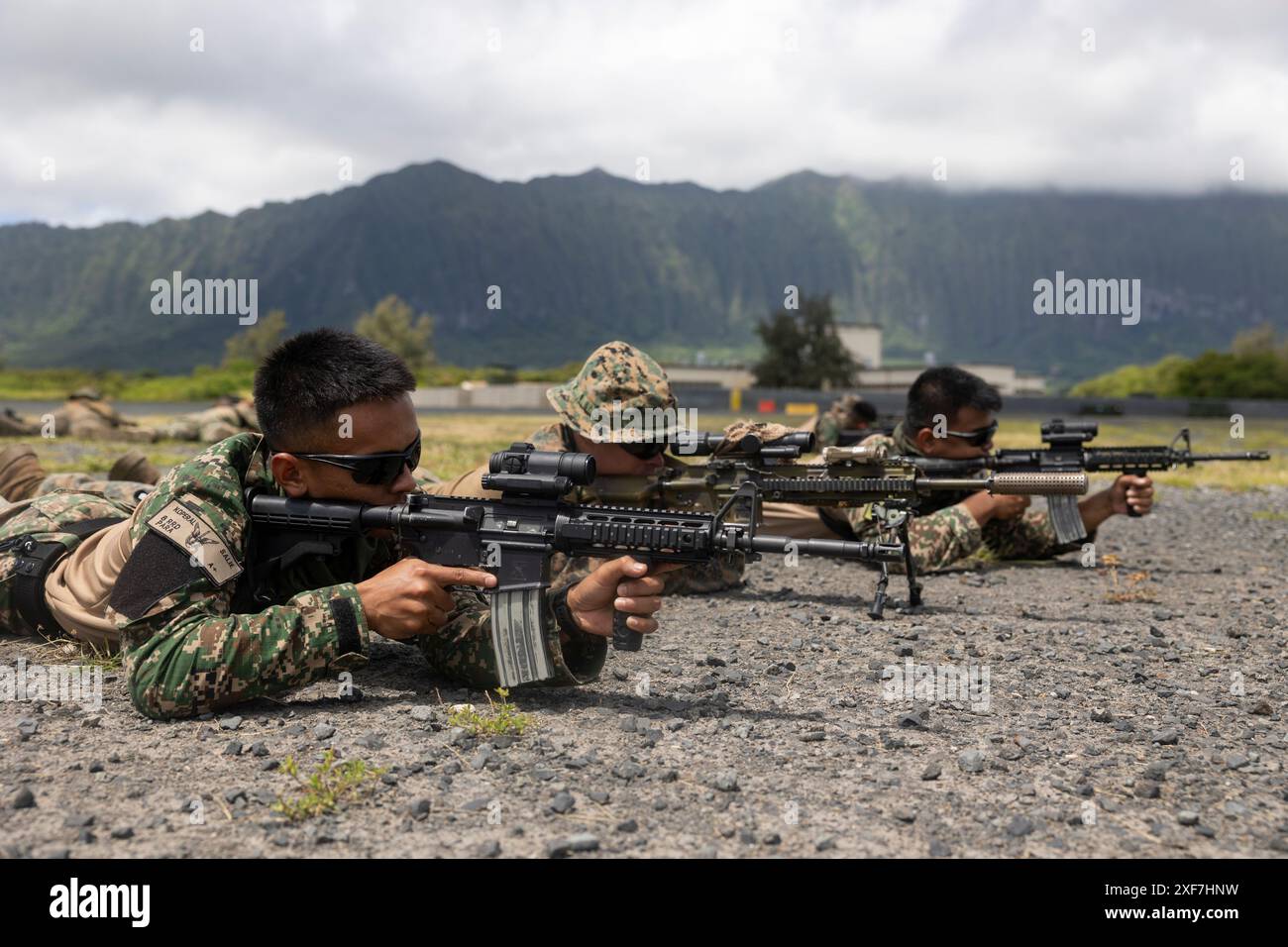 U.S. and Malaysian marines lay shoulder to shoulder during a patrol ...