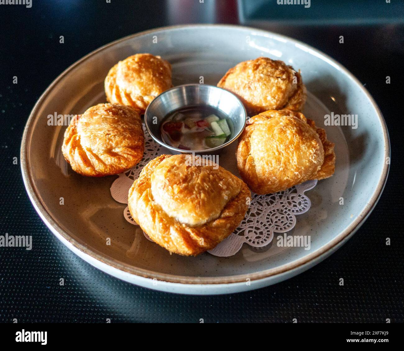 Golden-brown pastry parcels filled with spiced potatoes, peas, and ...