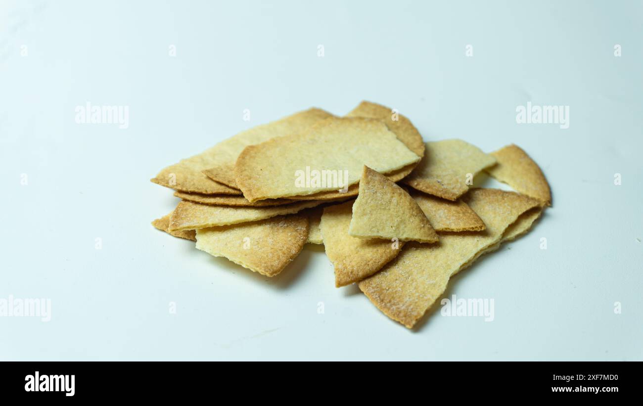 Broken baked chips crisps isolated on white background Stock Photo - Alamy