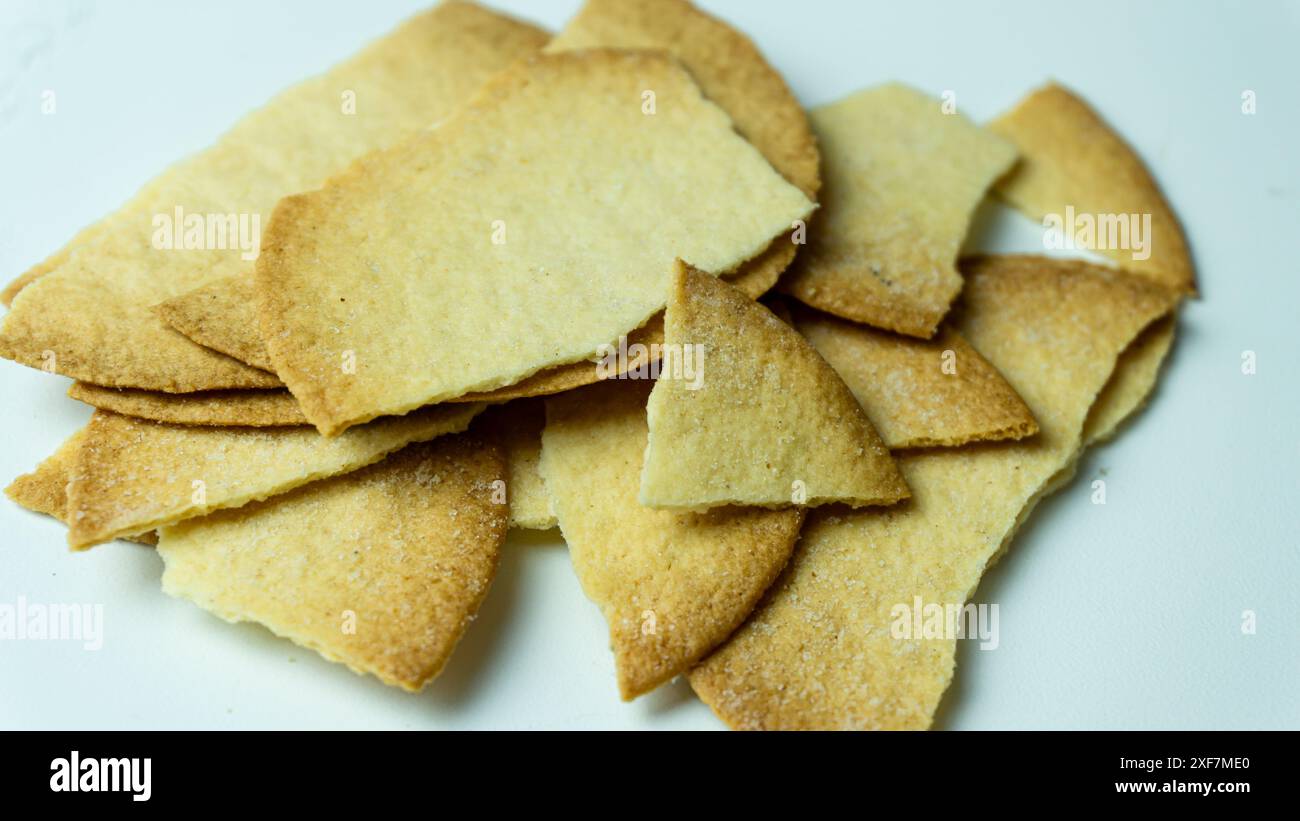 Broken baked chips crisps isolated on white background Stock Photo - Alamy