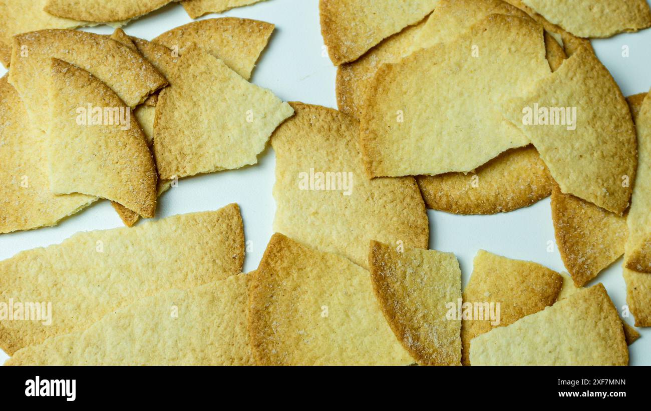 Broken baked chips crisps isolated on white background Stock Photo - Alamy