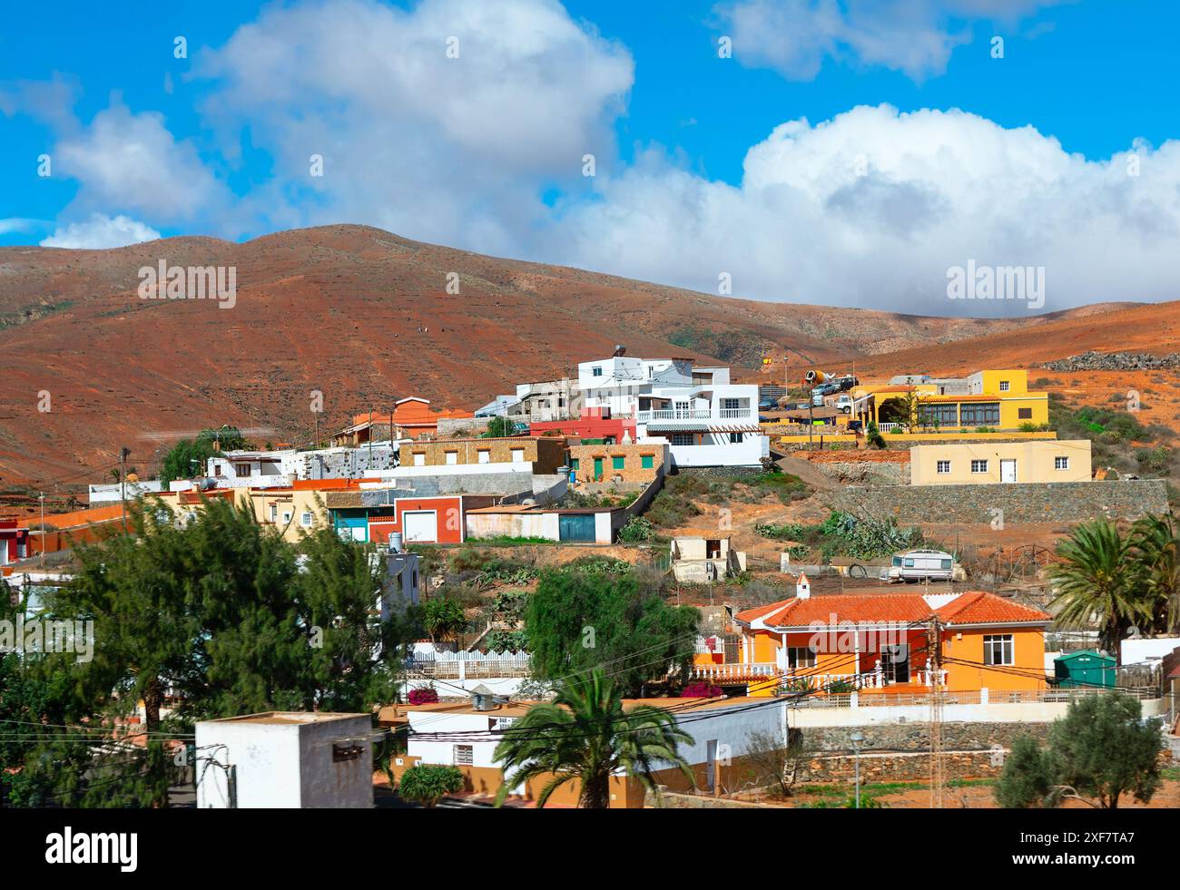 Scenic small town with houses and mountain backdrop in Fuerteventura ...