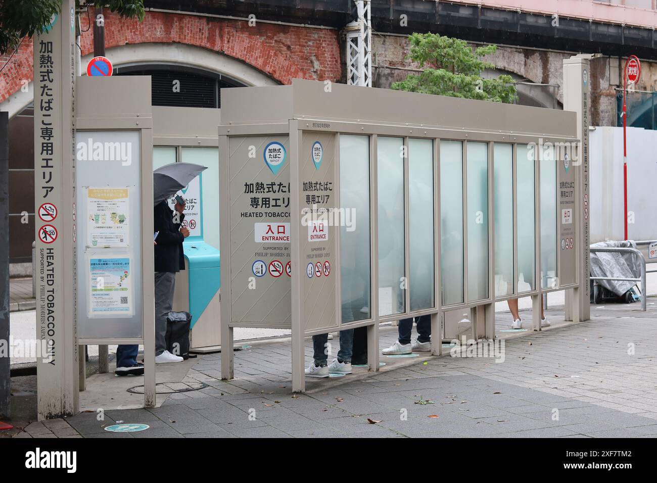 TOKYO, JAPAN - June 23, 2024: A designated smoking area on a street in ...