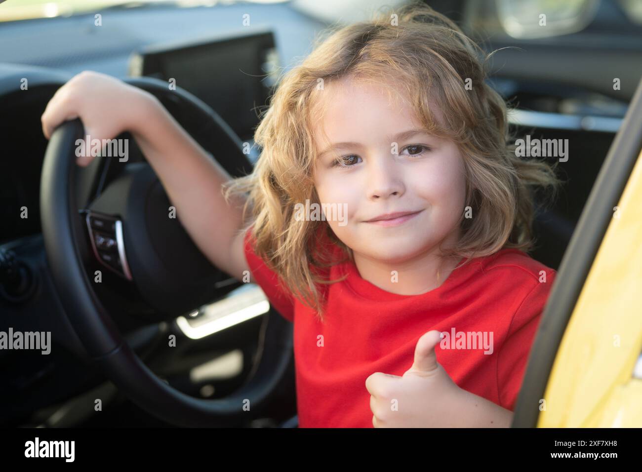 Kid Driver. Cute little boy pretending to drive. Kid in car with his ...