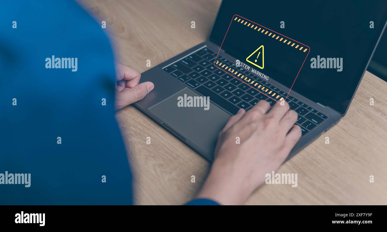 User Is Using Computer With System Warning Caution Sign For