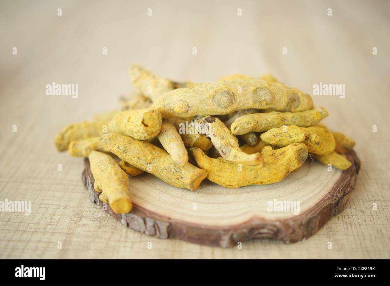 A detailed image captures turmeric roots drying in sunlight, part of ...