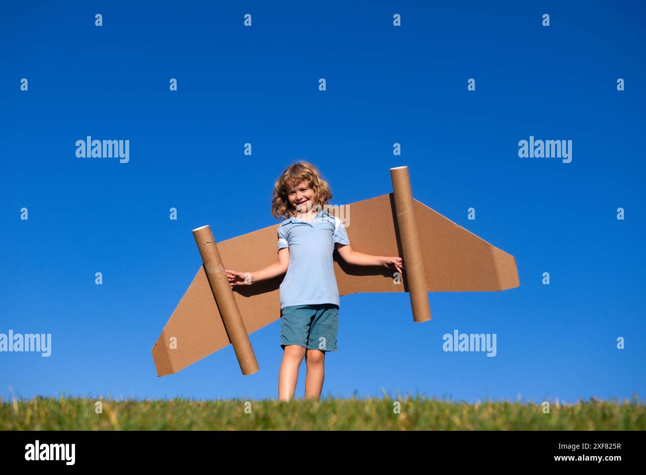 Dreams of travel. Child flying on jetpack with toy airplane on sky ...