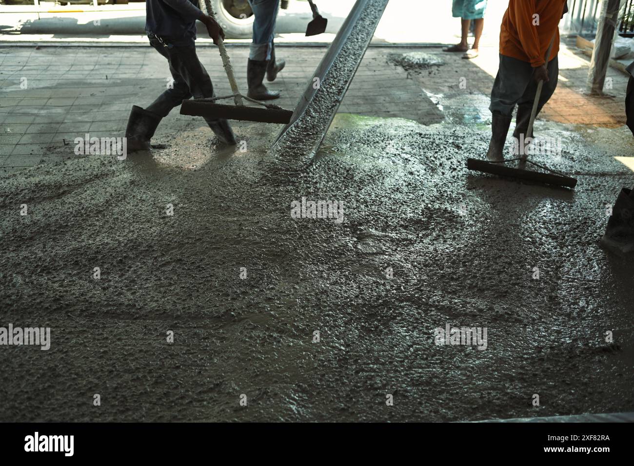 Construction site workers leveling cement hi-res stock photography and ...
