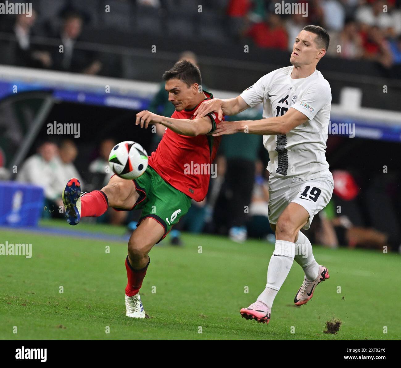 Frankfurt, Germany. 1st July, 2024. Joao Palhinha (L) of Portugal vies ...
