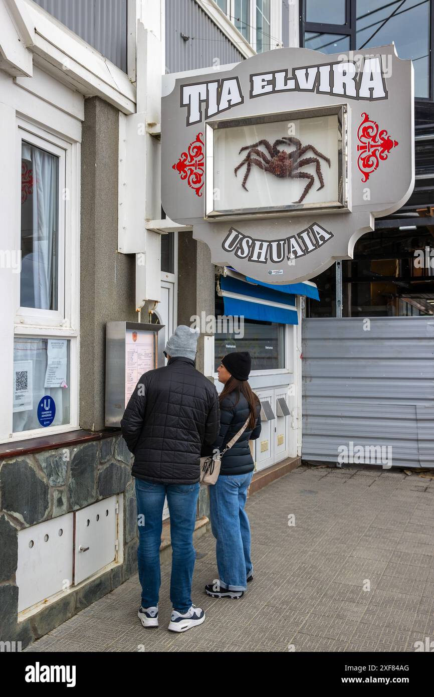 Two people inspect the menu of the Tia Elvira museum in Ushuaia, Argentina on Wednesday ...