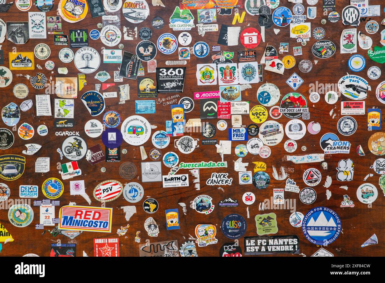 Stickers placed by visitors on the back of the town sign in Ushuaia ...