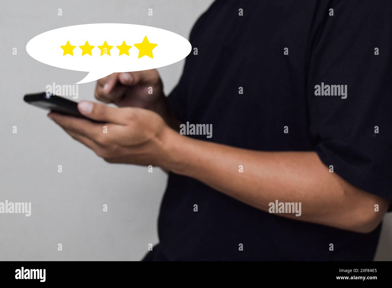 View of Customer hand pressing on smartphone screen with gold five star ...