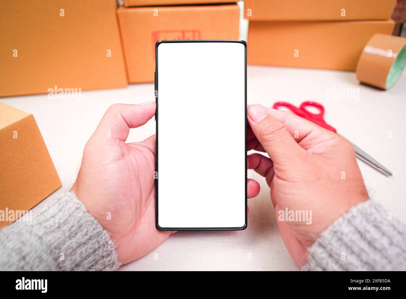 Goods delivery concept , mobile phone with blank white screen in a ...