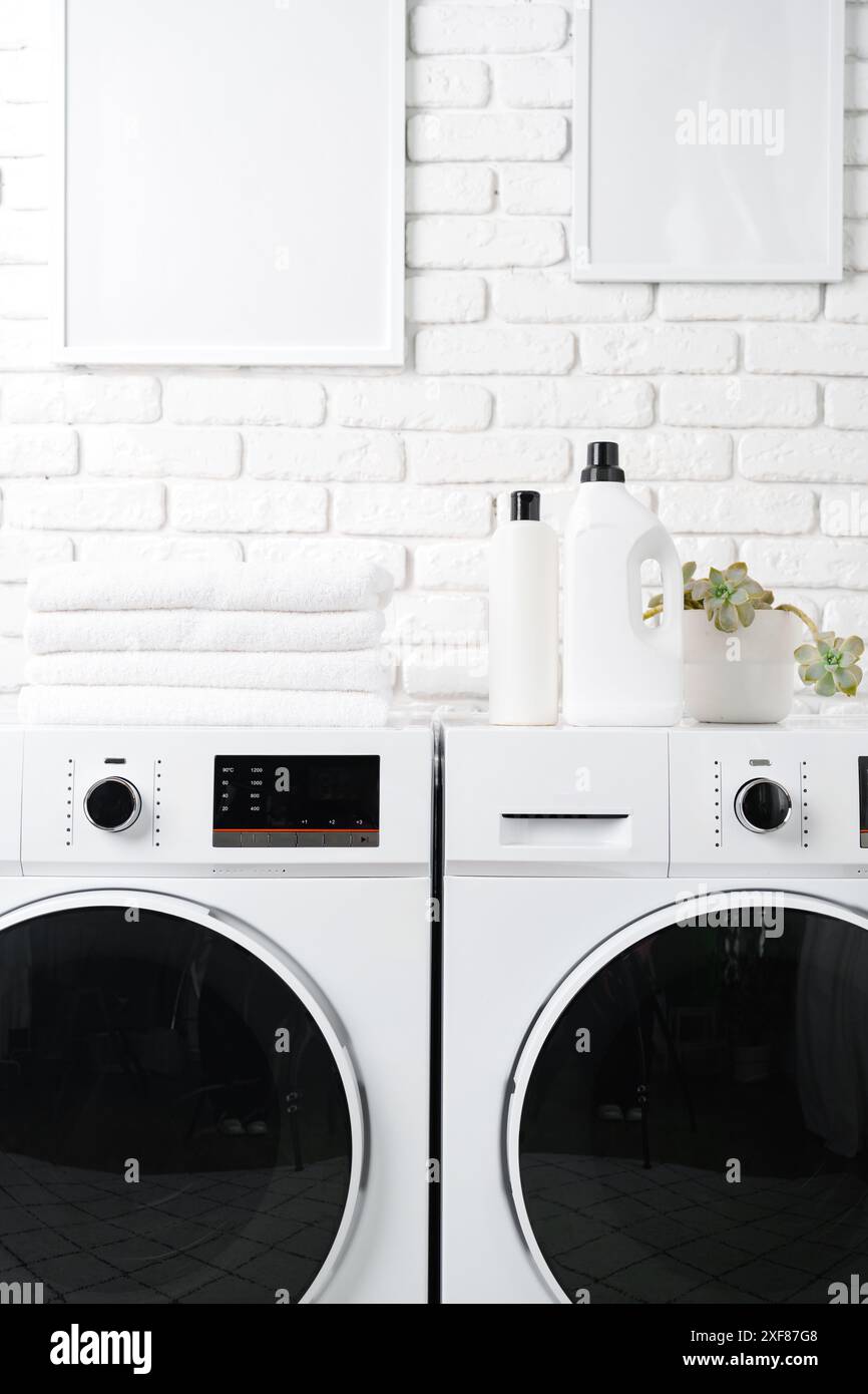 Two White Front Loading Washing Machines in Modern Laundry Room Stock ...