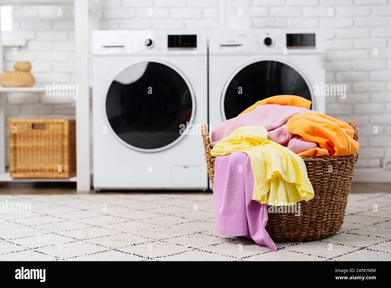 Laundry Basket With Clean Clothes in Front of Modern Washing Machines ...